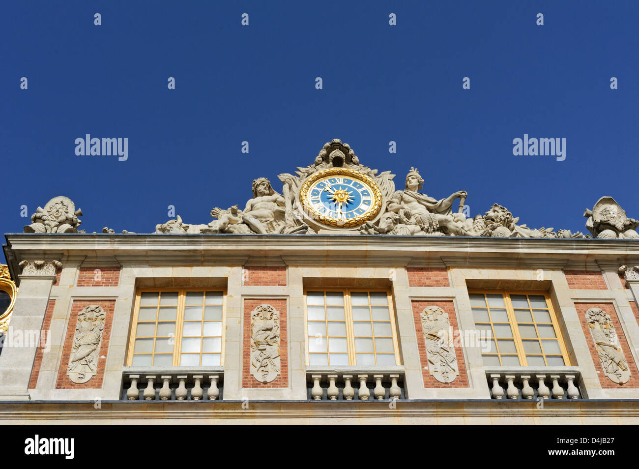 Clock and statues on the facade of Versailles Palace, Versailles ...