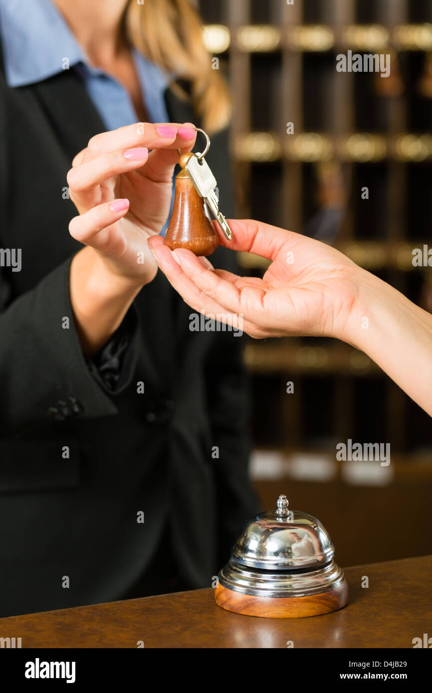 Reception - Guest checking in a hotel at the front desk, the room key ...