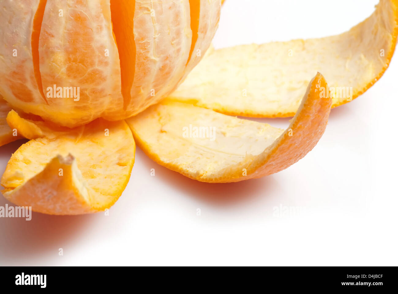 Unpeeled orange against white background Stock Photo - Alamy