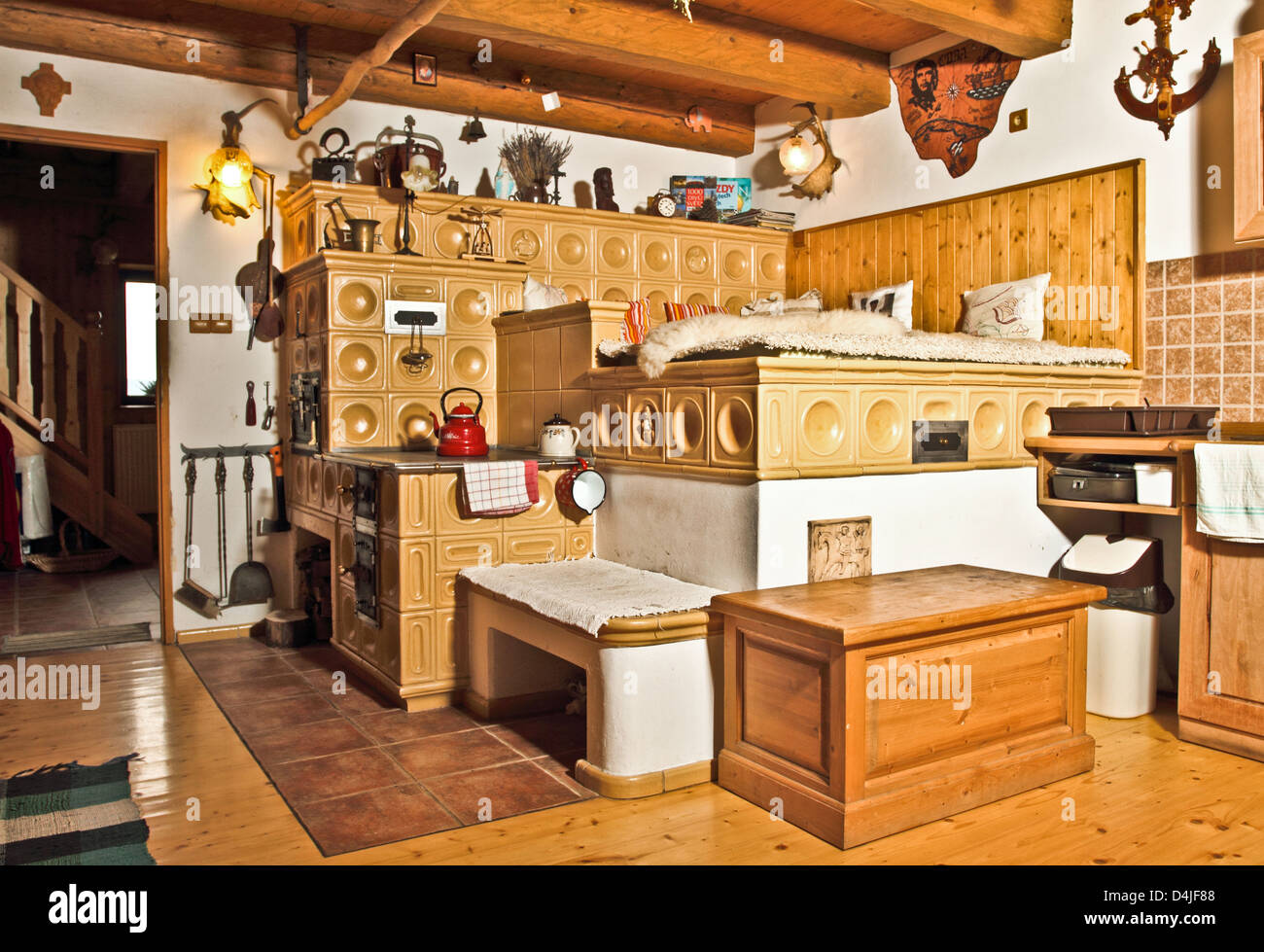 wooden interior with tiled stove Stock Photo - Alamy