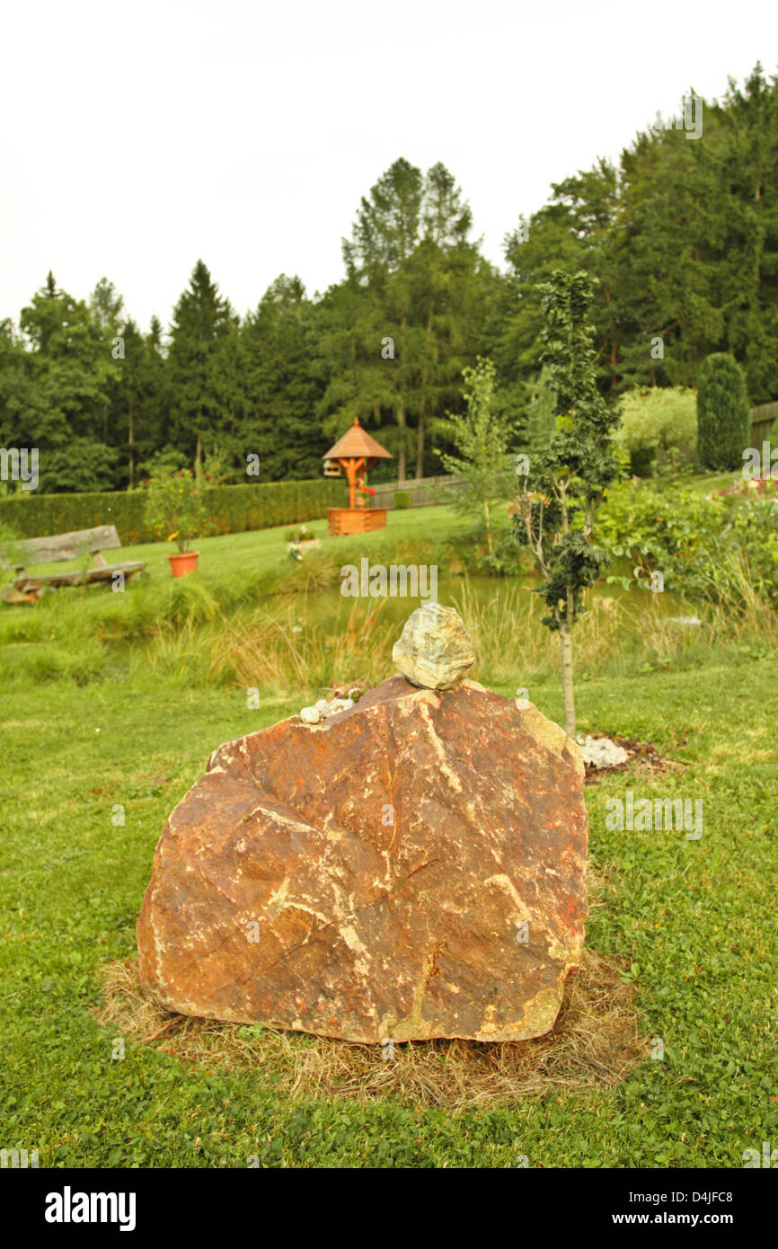 large stone in the garden Stock Photo - Alamy