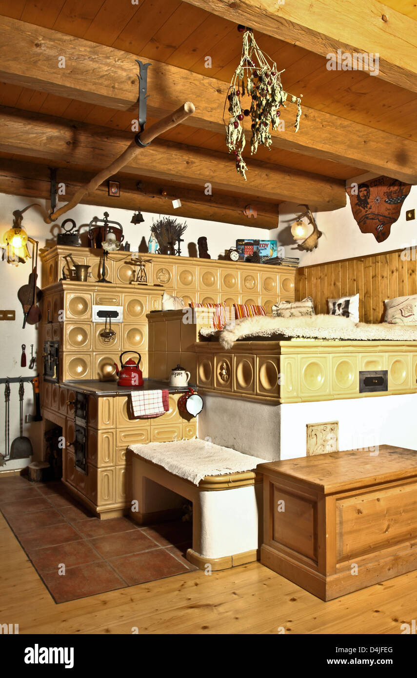 wooden interior with tiled stove Stock Photo - Alamy