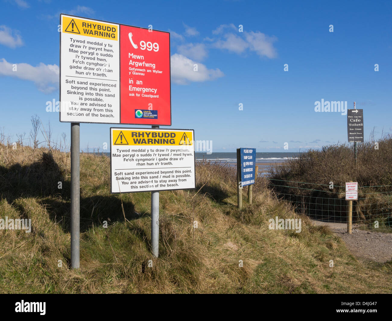 Bilingual danger signs warning of soft sand (quicksand) on Traeth ...