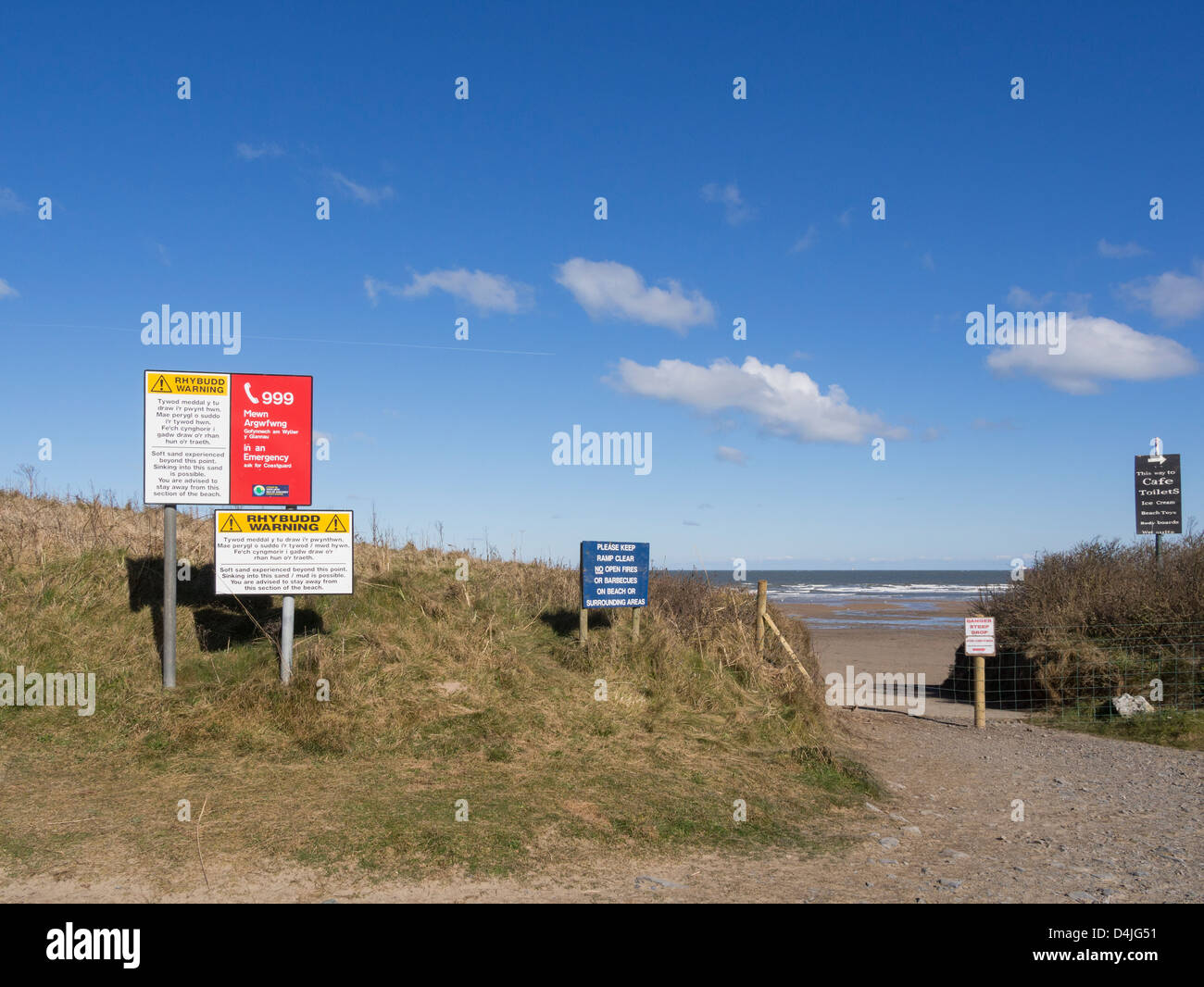 Bilingual danger signs warning of soft sand (quicksand) on Traeth ...