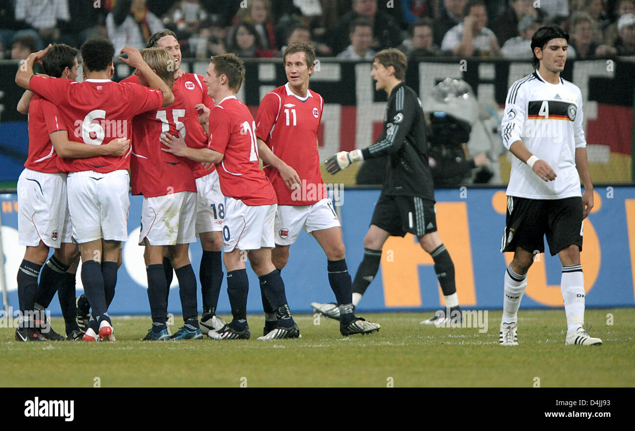 German goalkeeper Rene Adler (2-R) and player Mario Gomez (R) stand ...