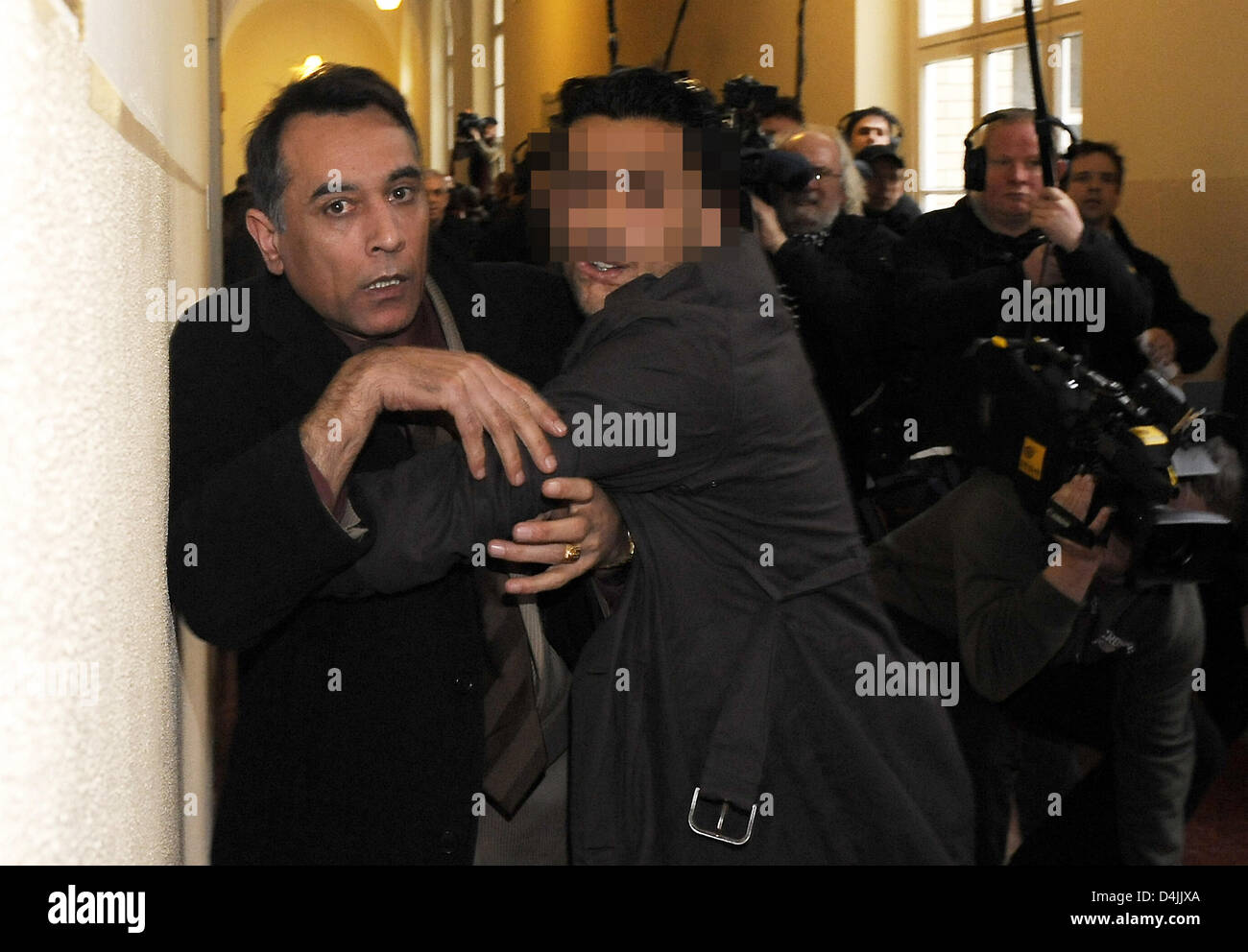 The father (L) of defendant Ahmad-Sobair O. flips after the ...