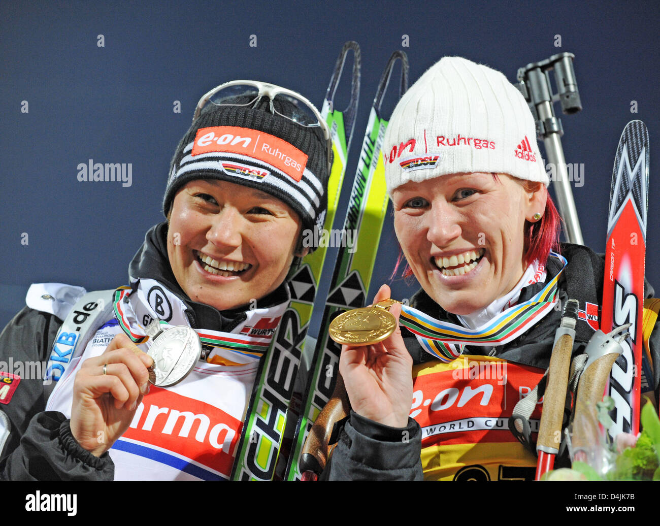 German biathlets Kati Wilhelm (R) and Simone Hauswald show their medals ...