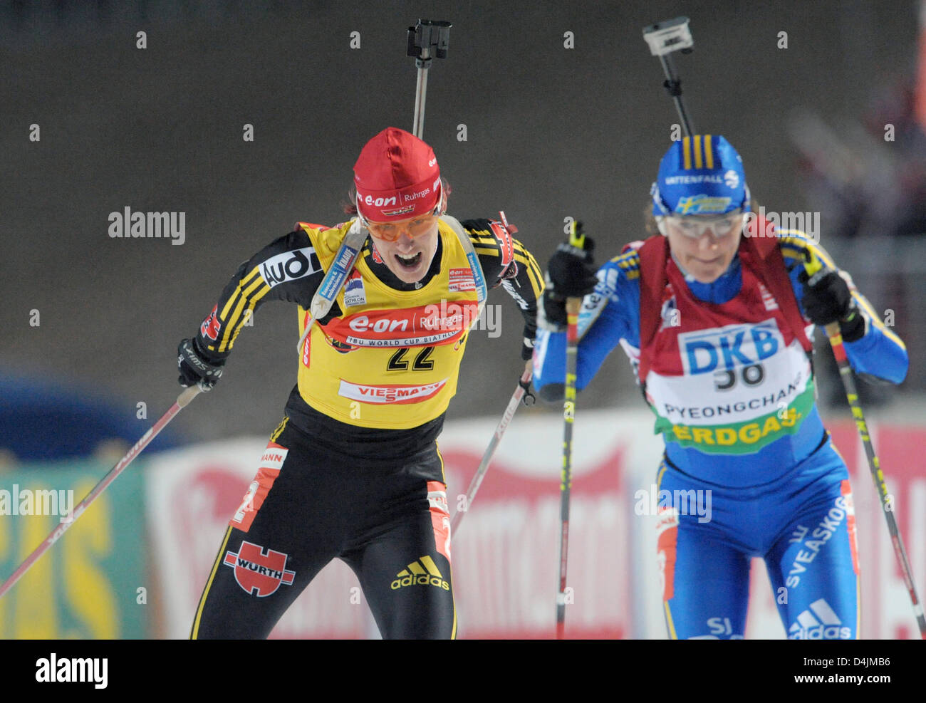German Kati Wilhelm (L) passes Swedish Helena Jonsson (R) on her way to ...