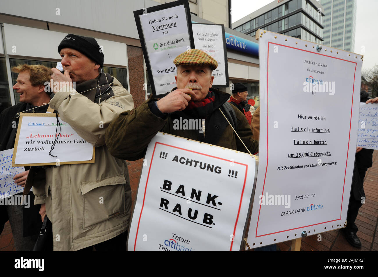 A poster reading ?Attention!!! Bank Robbery? is held up by a marred ...