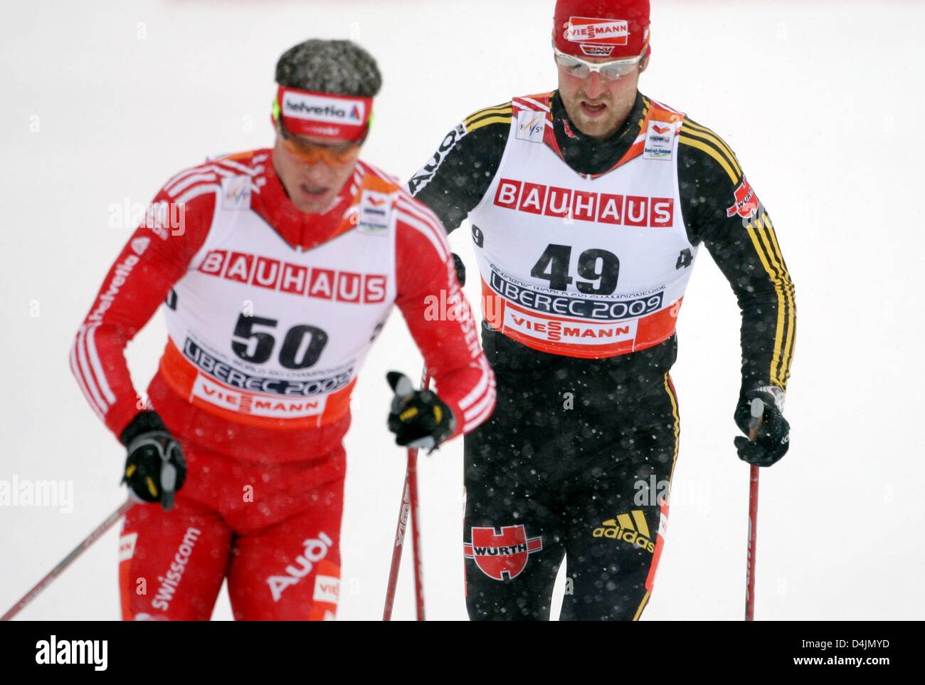 Germany?s Axel Teichmann (R) is overtaken by Swiss skier Dario Cologna ...