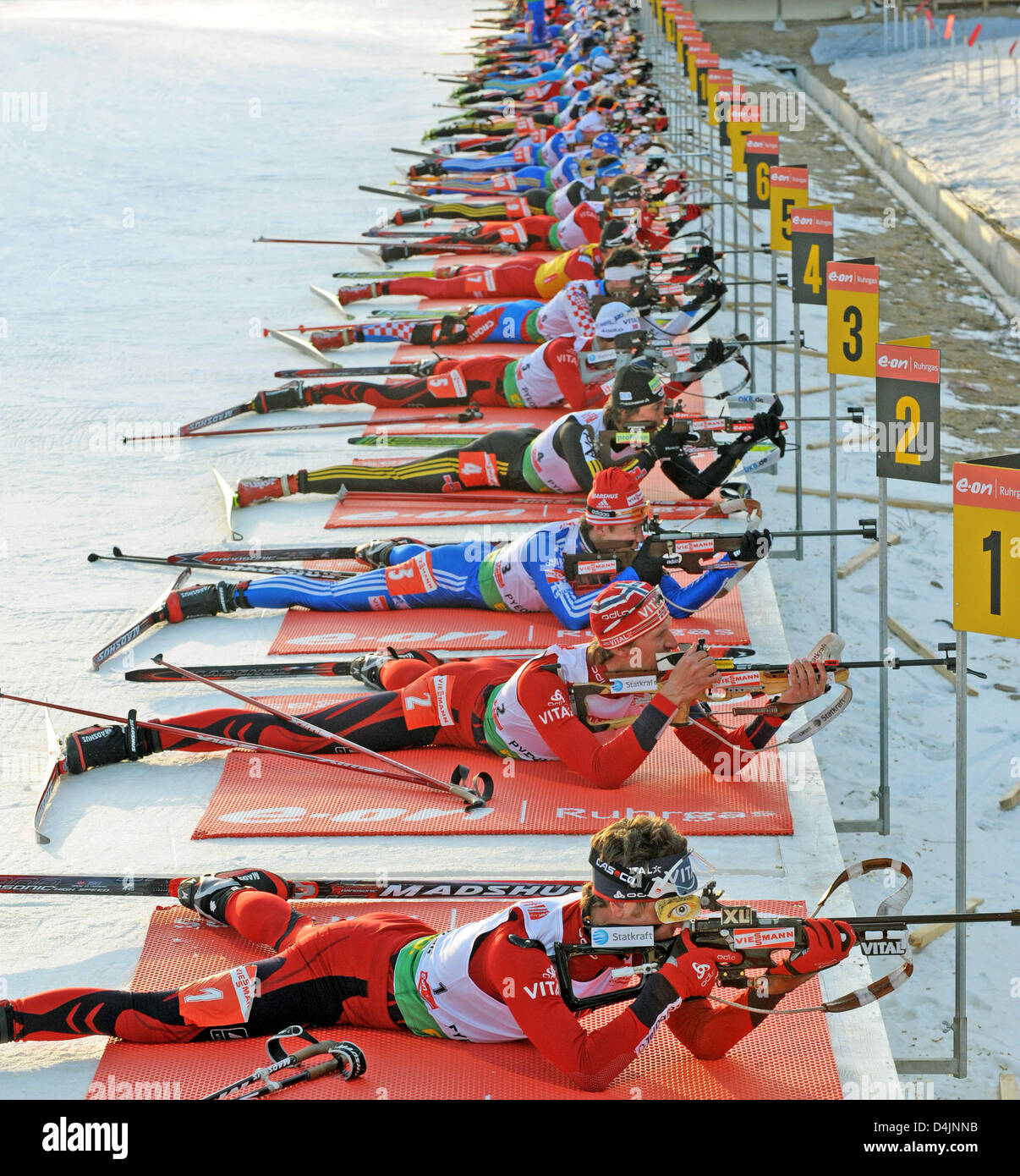 Biathletes lie at the shooting range during the men?s 15km competition ...