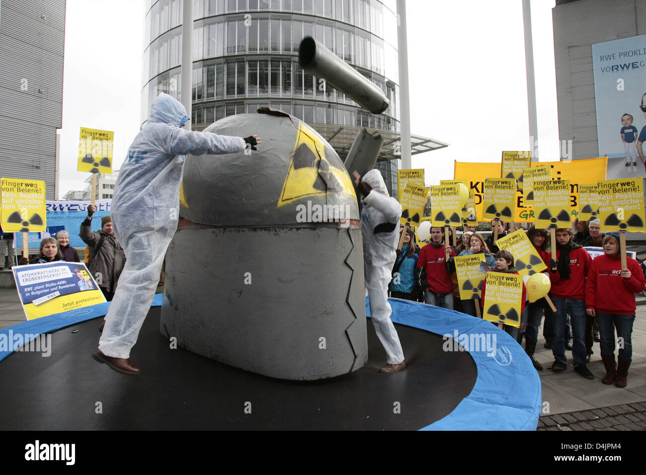 Protestors destroy a model of a nuclear power plant by jumping on a ...