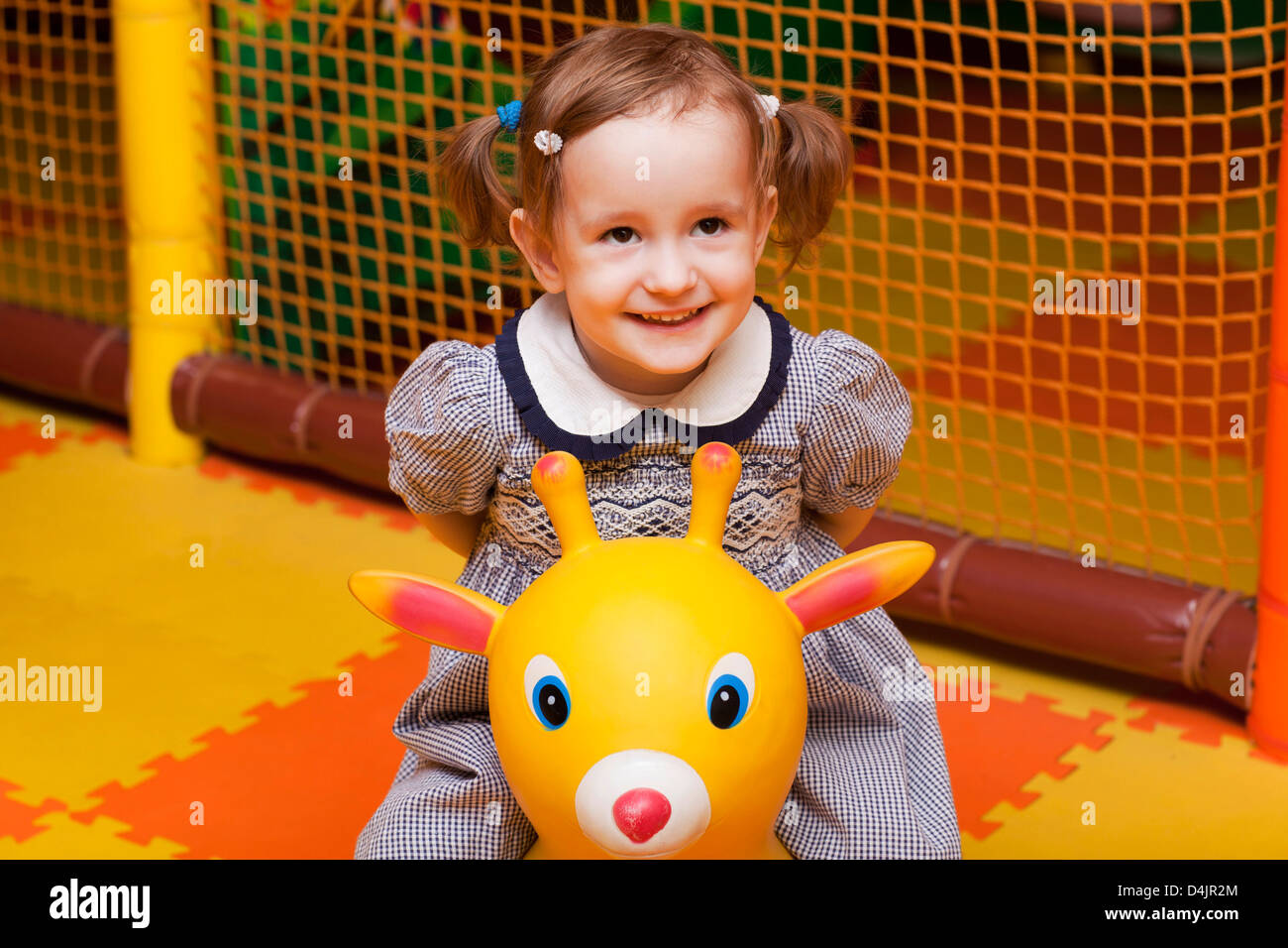 little happy girl on playground laughing Stock Photo - Alamy