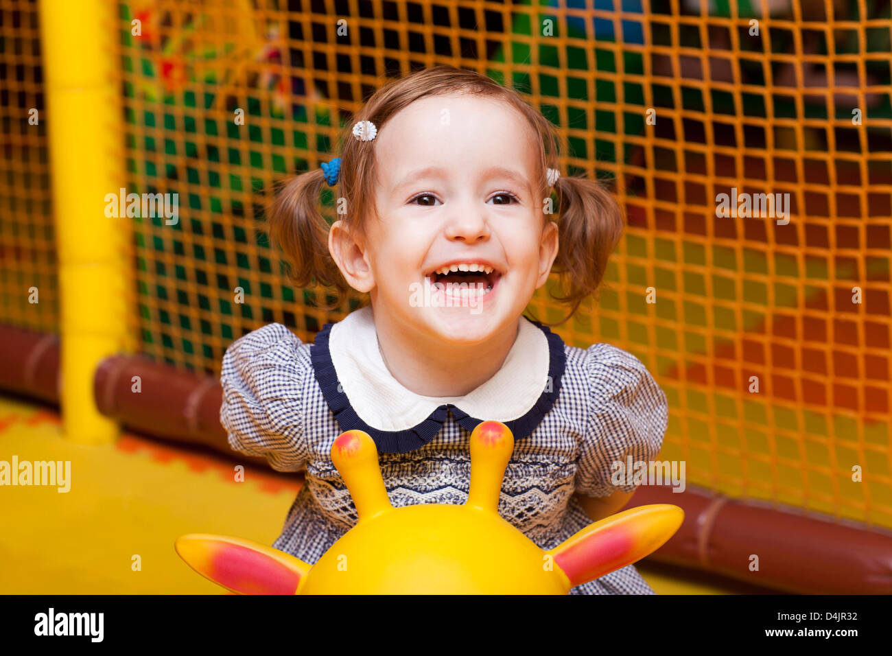 little happy girl on playground laughing Stock Photo - Alamy