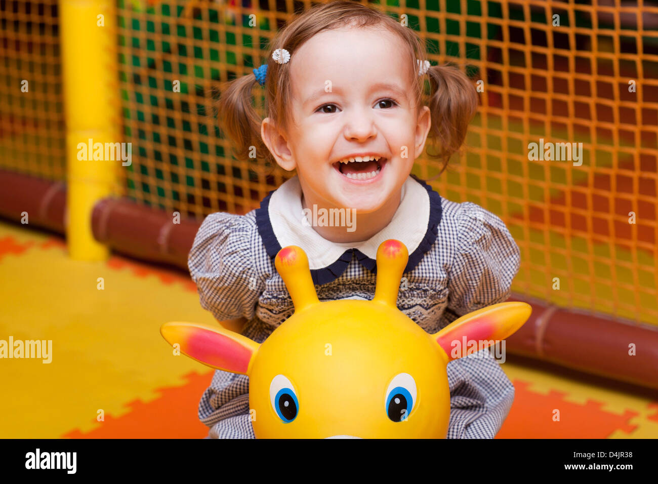 little happy girl on playground laughing Stock Photo - Alamy