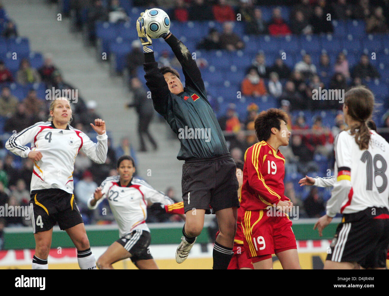 China?s goalkeeper Zhang Yanru (C) saves a ball ahead of Germany?s Babett Peter (L) during the ...