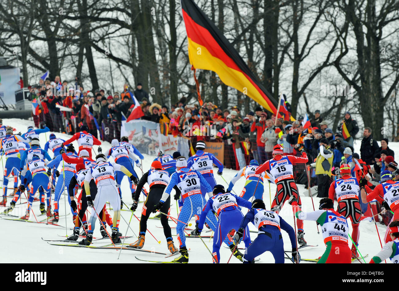 Cross-country skiers pass a German flag during the men?s 50km cross ...