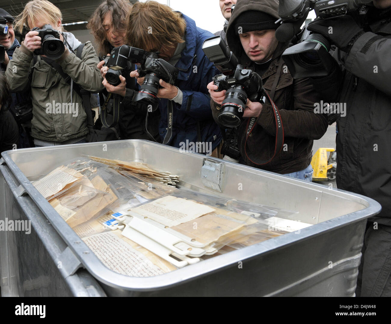 Journalists photograph a container filled with documents that have ...