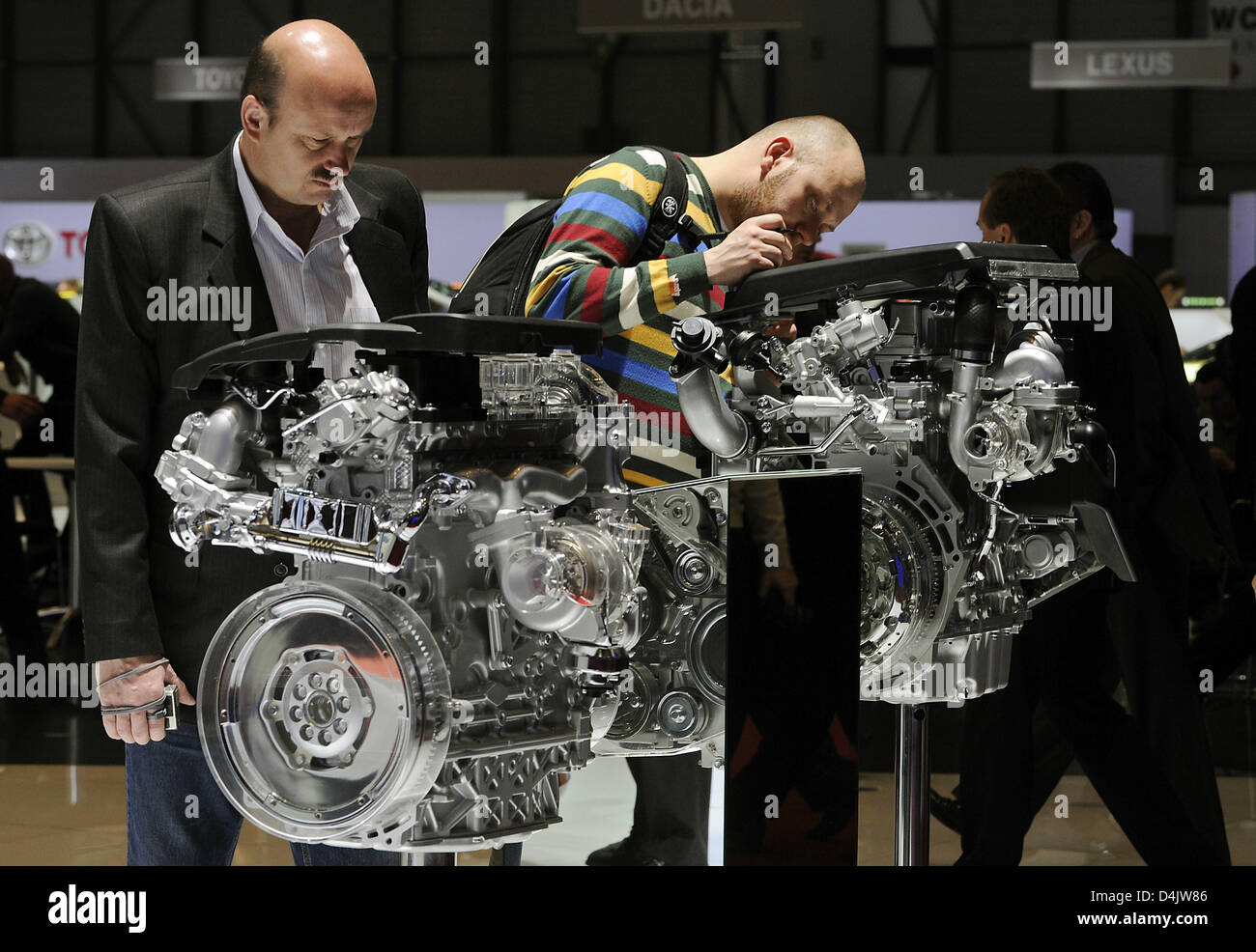Visitors observe engines at the Mazda stand on the second press day of ...