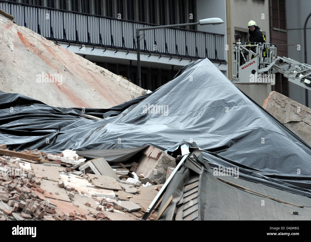 A firefighter hovers over Cologne?s collapsed Historic City Archive in ...