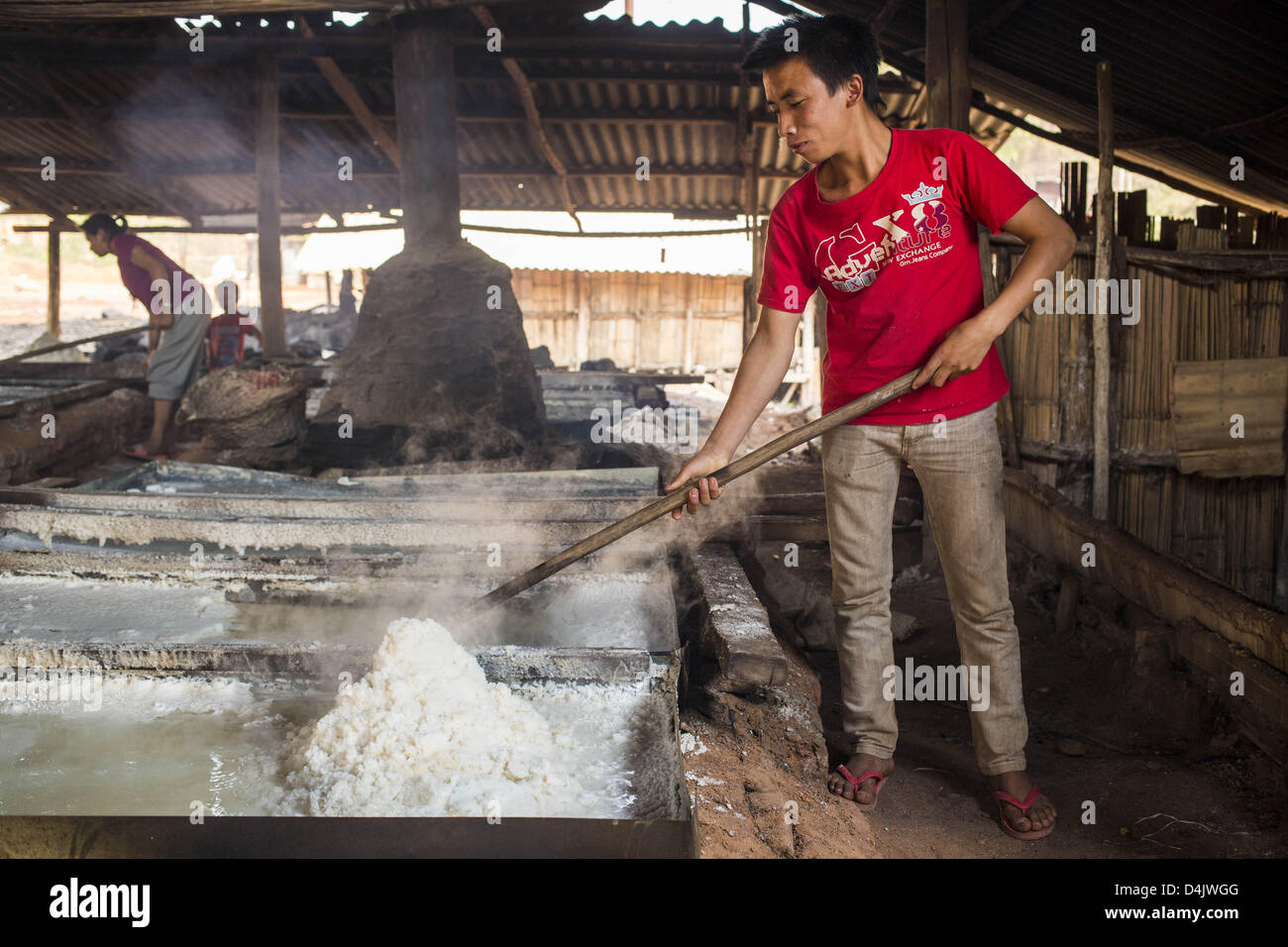 March 13, 2013 - Boten, Luang Namtha, Laos - A worker piles up salt in ...