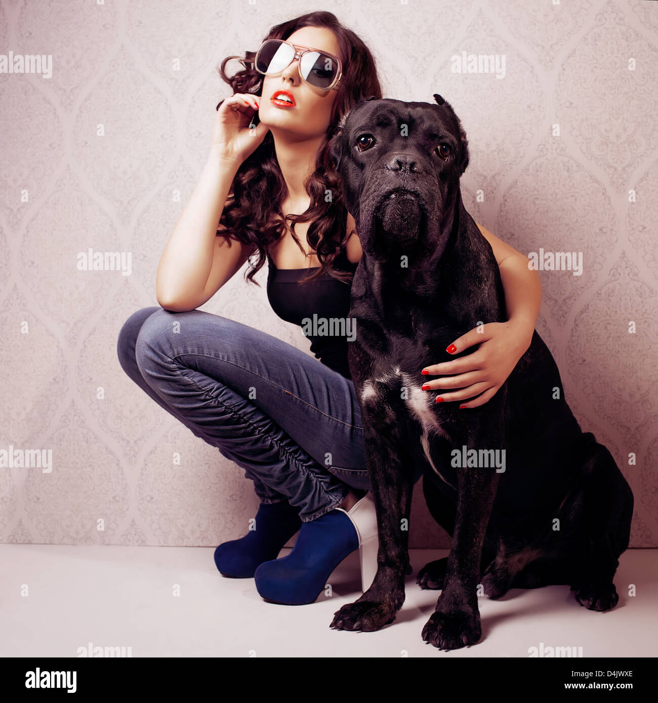 Pretty young woman smiling while embracing her cane corso Stock Photo ...