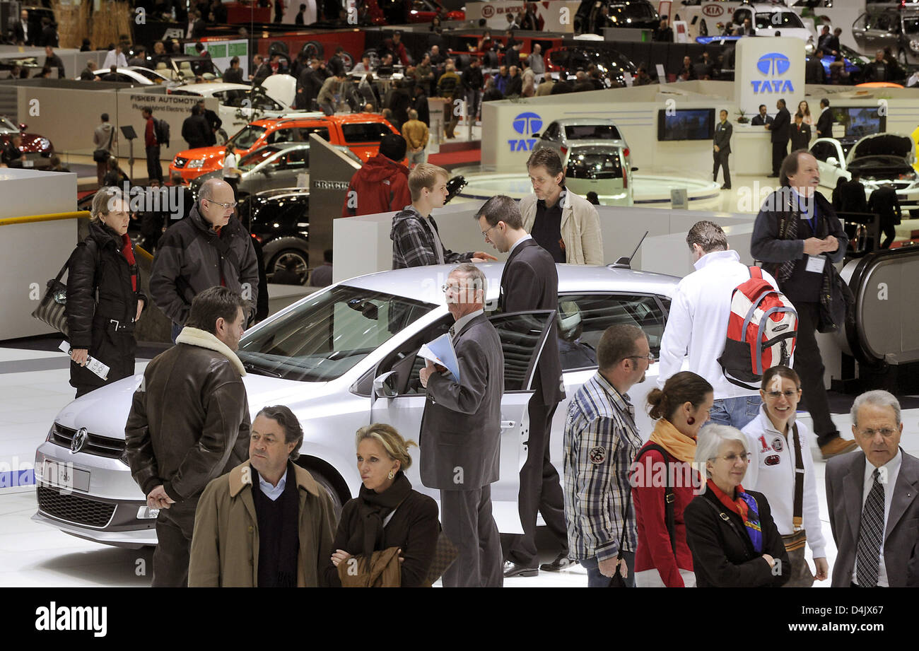 Visitors look at a VW Polo at the 79th International Motor Show and ...