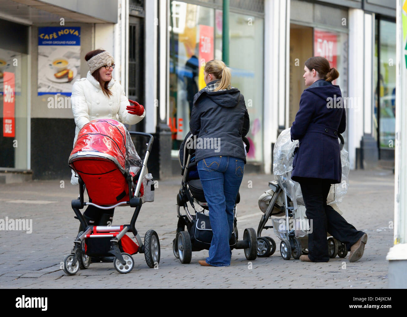 Three mums with three pushchairs. Stramongate, Kendal, Cumbria, England ...