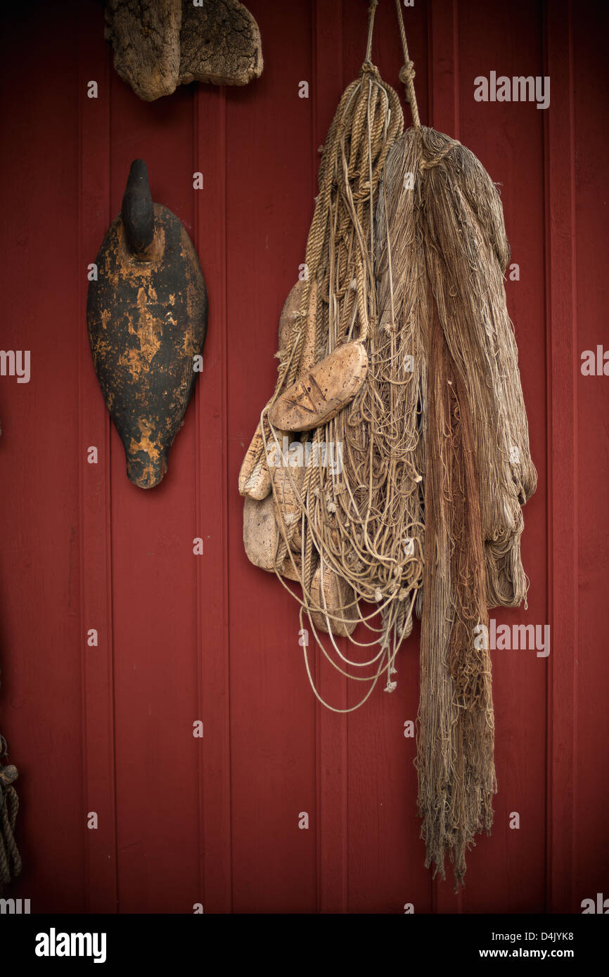 Fishing net hanging from wall Stock Photo - Alamy