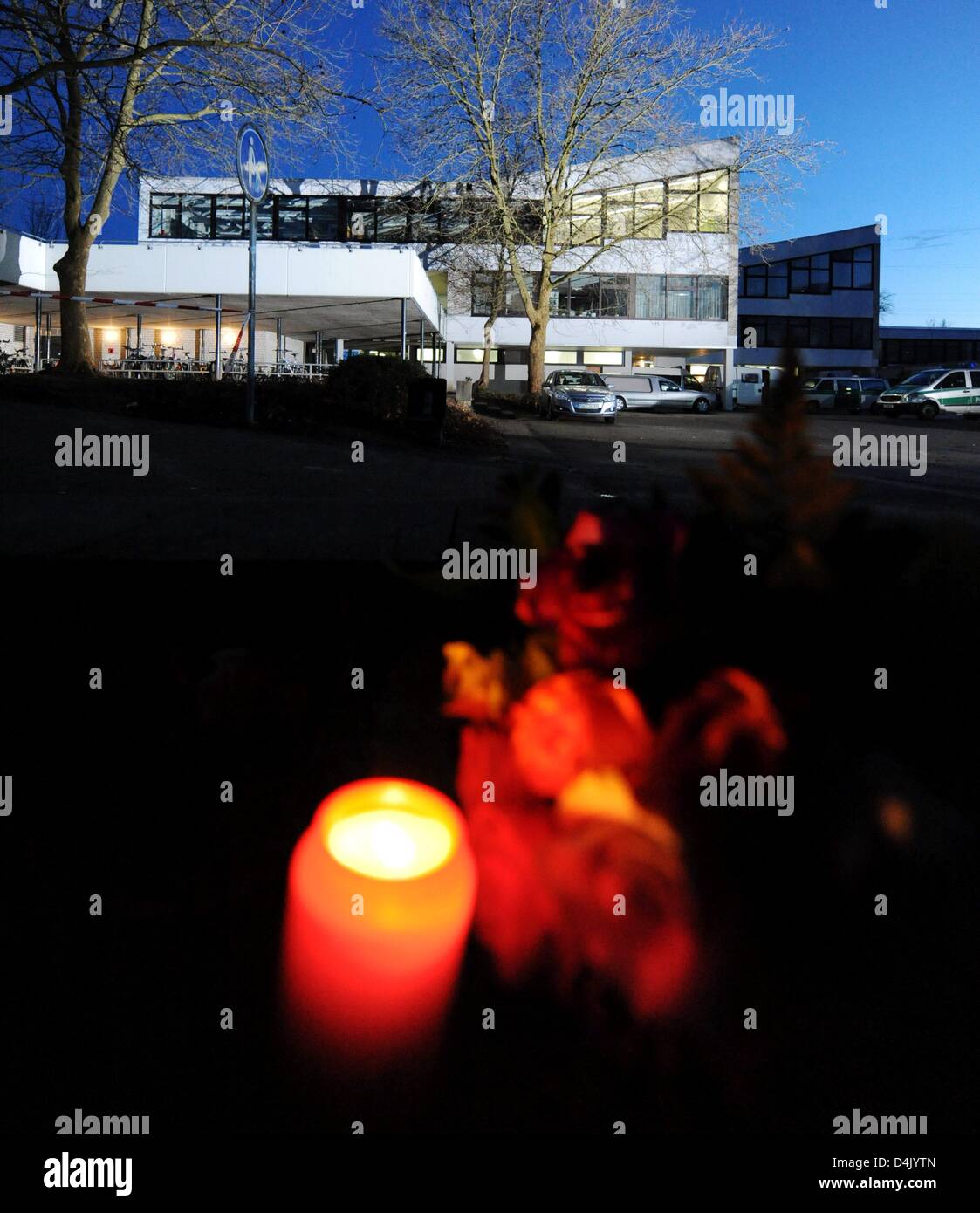 A candle and a flower seen in front of the secondary school ...