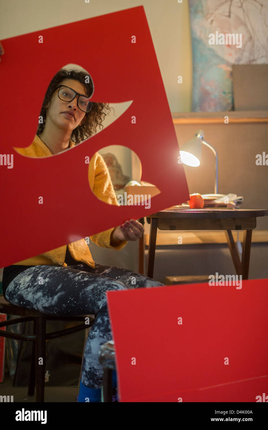 Artist cutting out red cardboard Stock Photo - Alamy