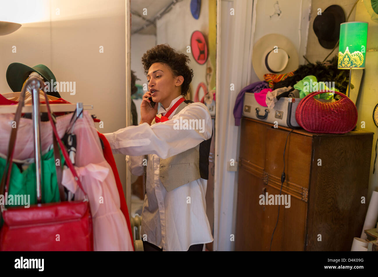 Woman on cell phone in clothes shop Stock Photo - Alamy