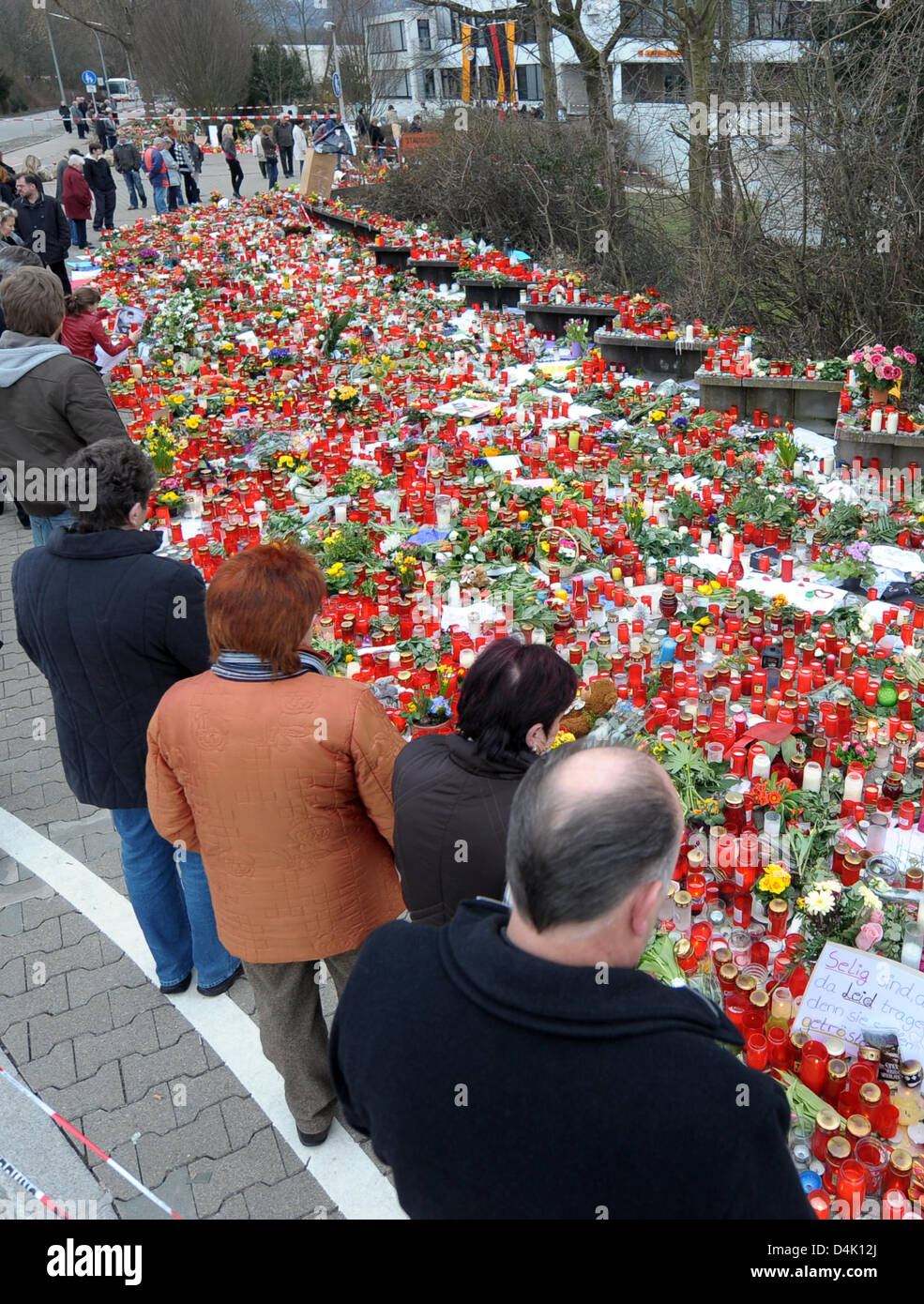 Mourners for the victims of the Winnenden rampage shooting stand at an ...