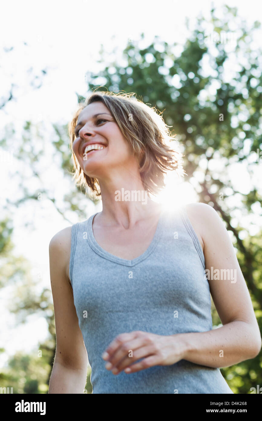 Smiling woman walking outdoors Stock Photo - Alamy