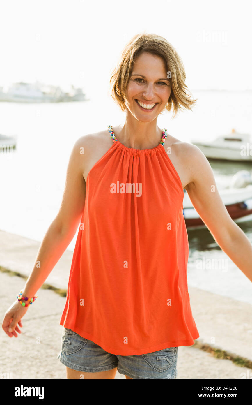 Smiling woman walking outdoors Stock Photo - Alamy