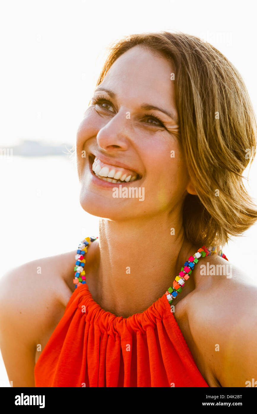 Carefree woman 40s smiling outdoors hi-res stock photography and images ...