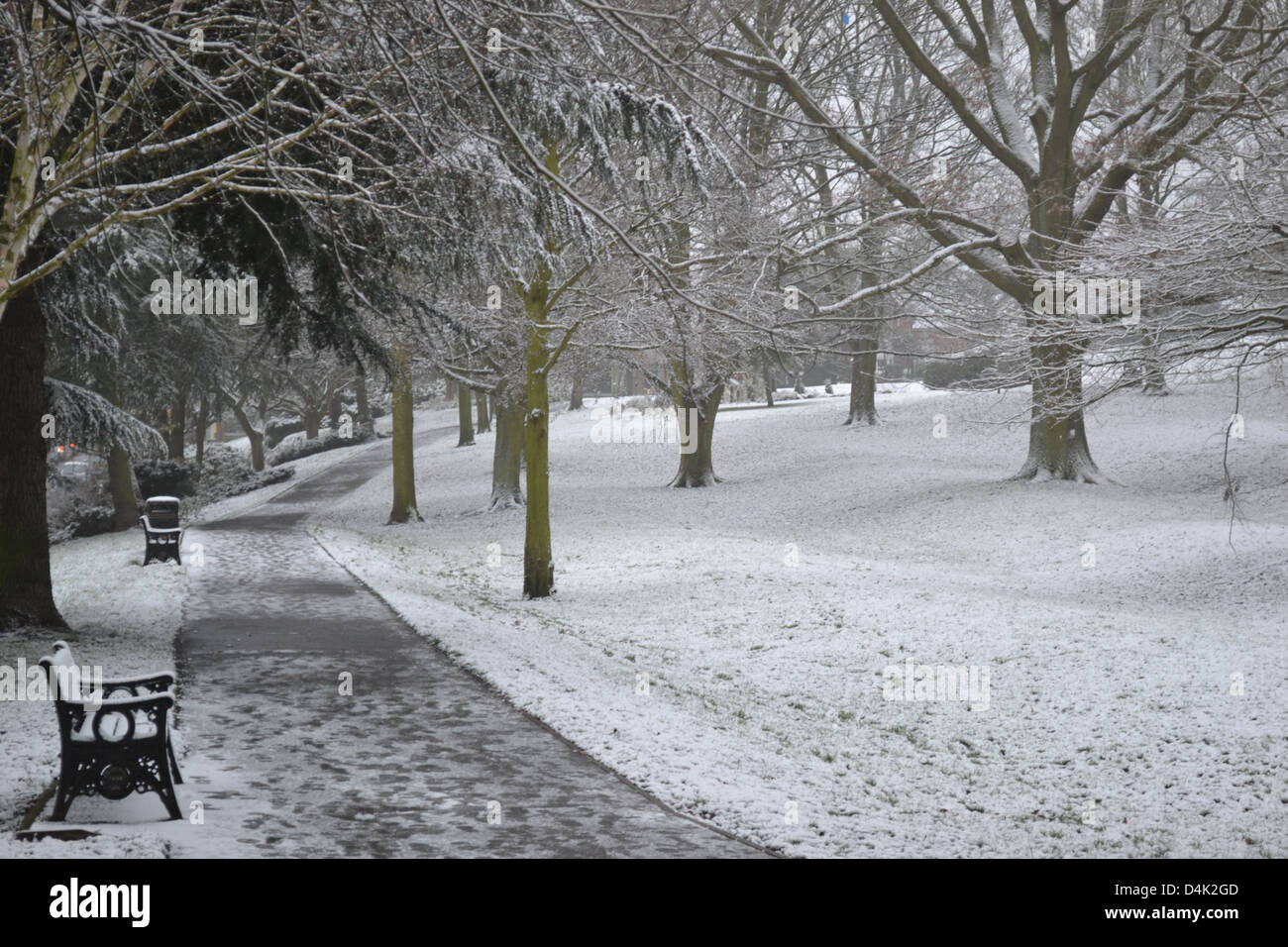 A winter swept park in the center of a town, on a cold and frosty ...