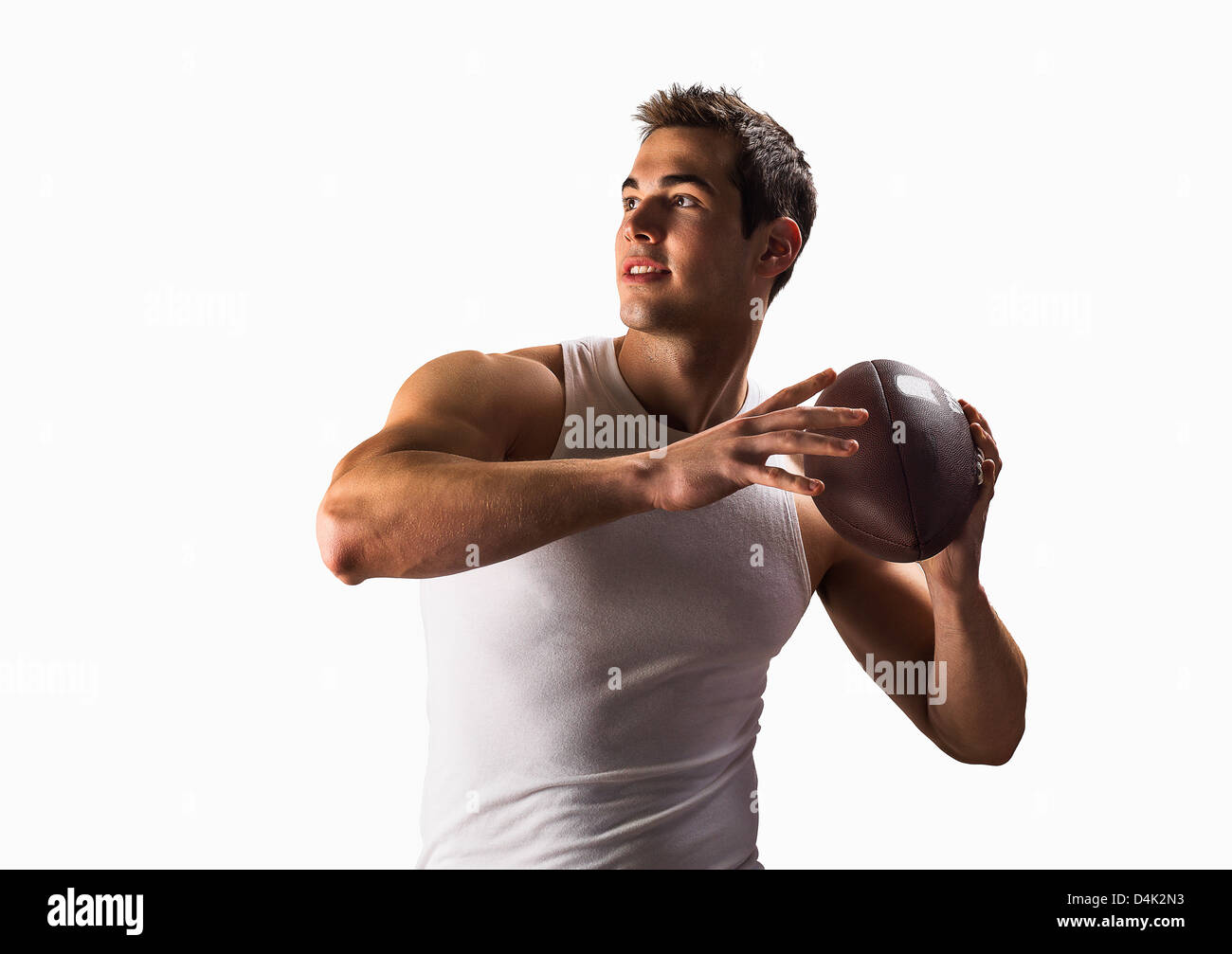 Man poised to throw football Stock Photo - Alamy