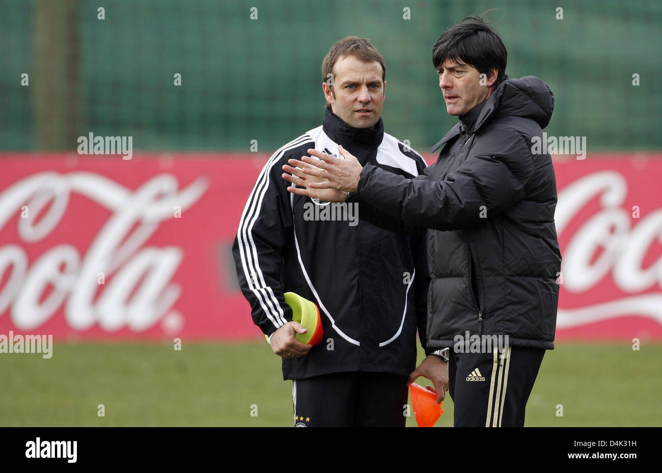 Coach of the German national soccer team, Joachim Loew (R), talks to ...