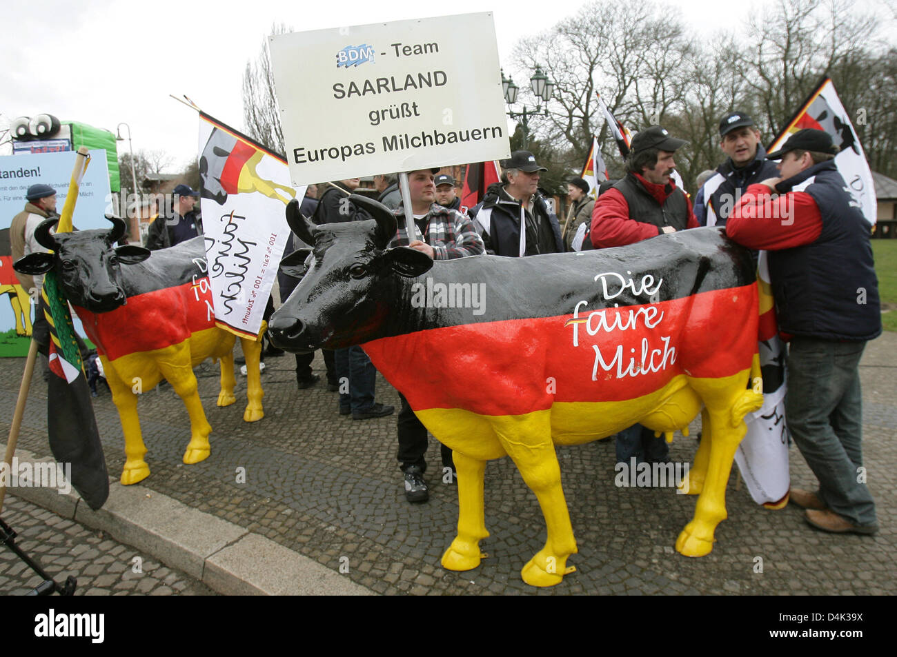 Farmers demonstrate with cow models outside the spring conference of ...