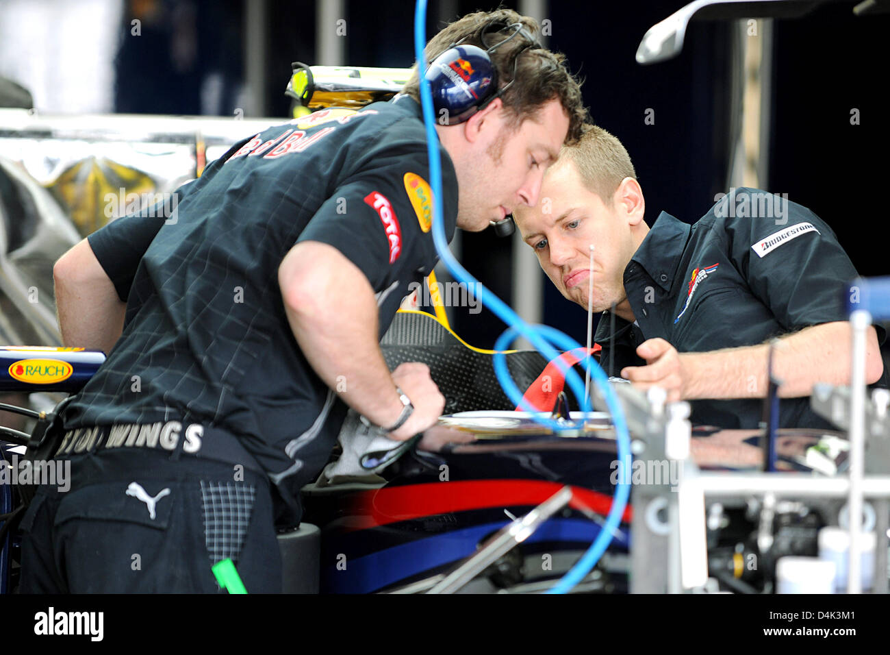 German Formula One driver Sebastian Vettel (R) of Red Bull gestures ...