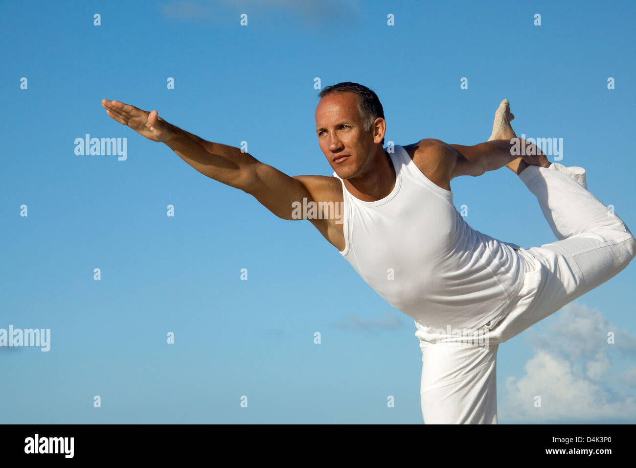 Man practicing yoga outdoors Stock Photo - Alamy