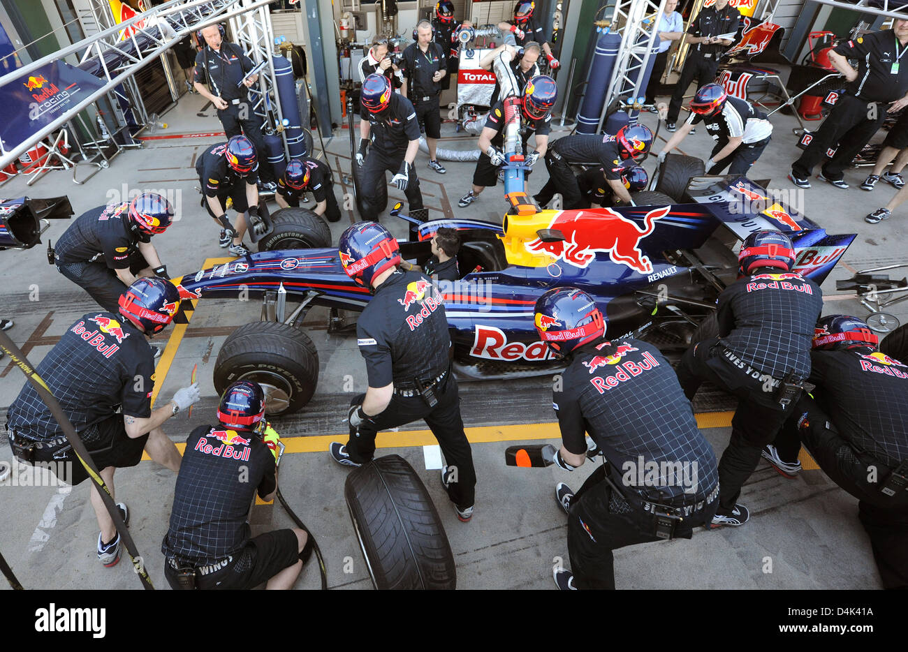 Mechanics of Red Bull are pictured during a pitstop practice in front ...