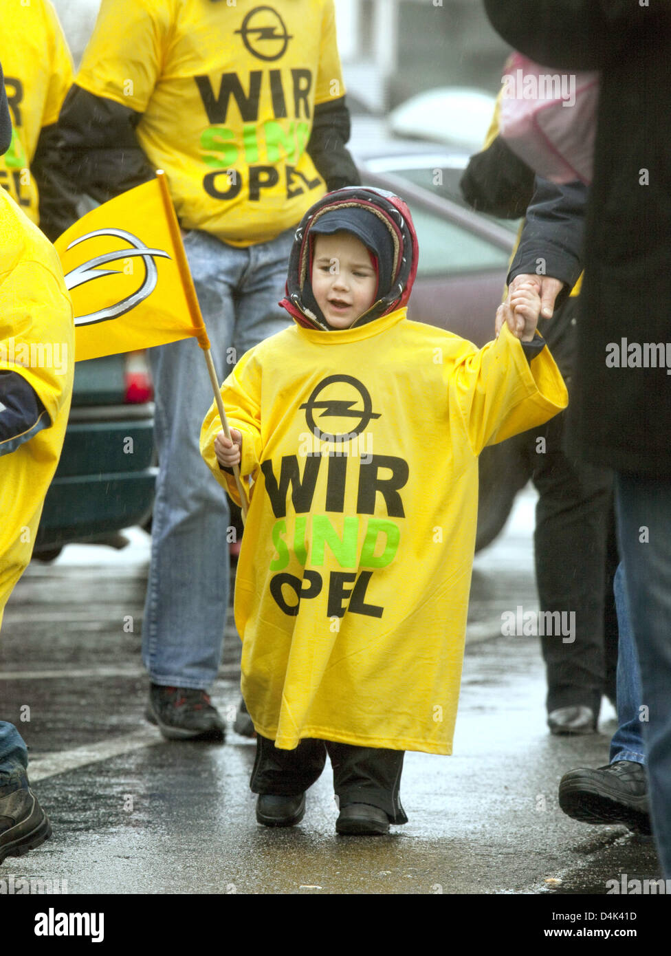 Four-year-old Jan-Moritz Kulas holds his father?s hand as he wears as T ...