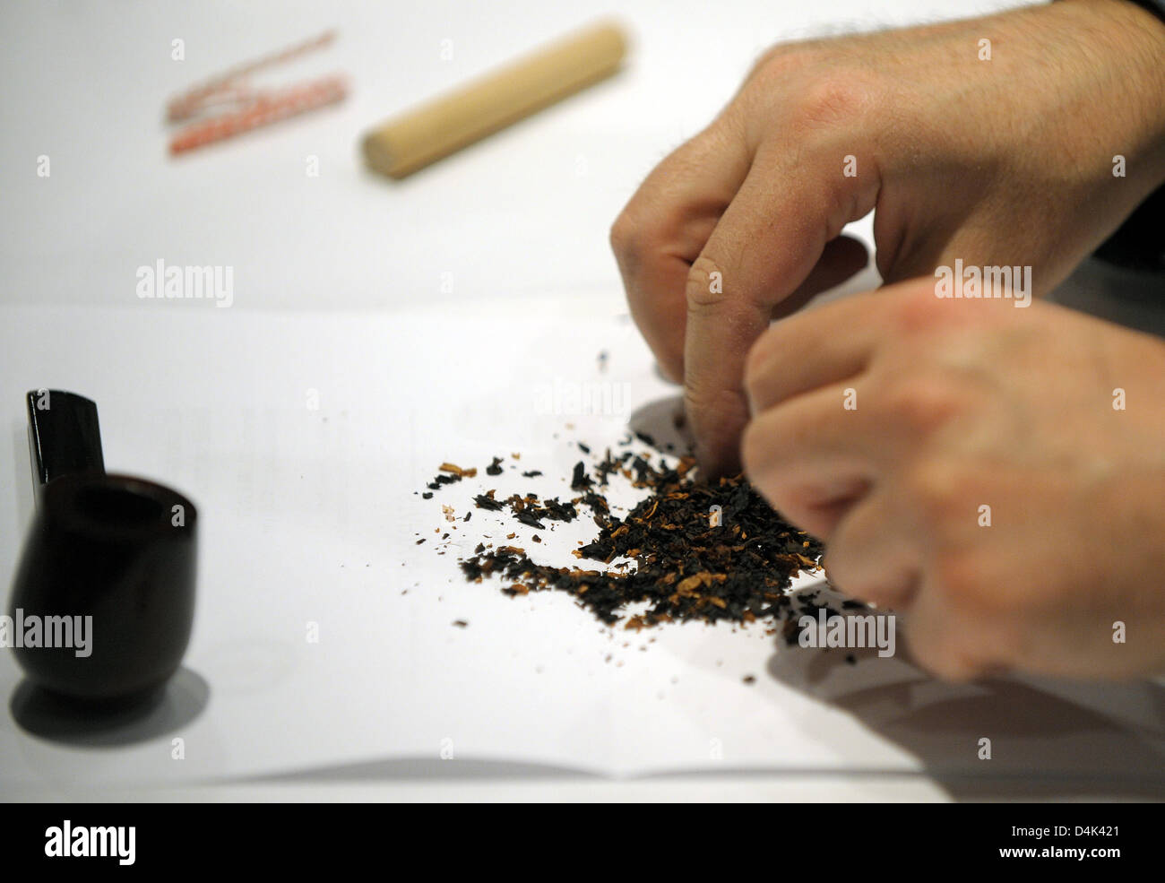 A participant fills his competition-pipe with tobacco during the ?12th ...