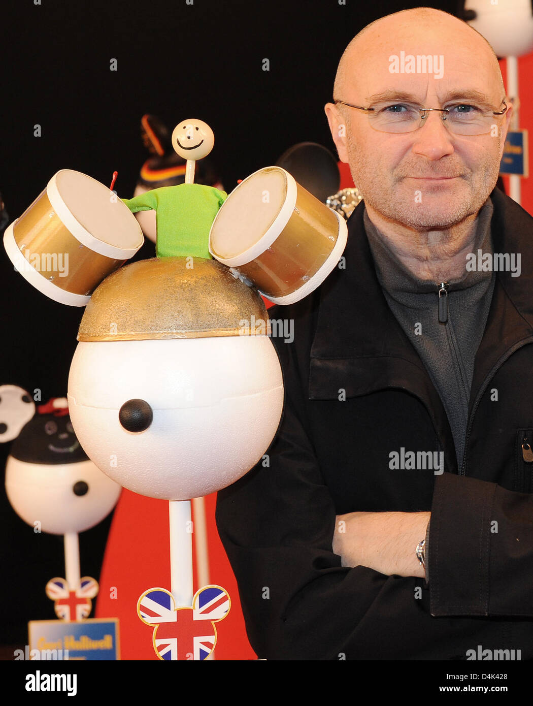 British singer Phil Collins presents his self-made Mickey Mouse ears ...