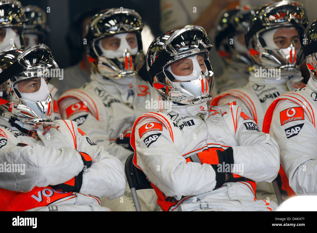 McLaren Mercedes mechanics watch the race on a monitor inside their ...