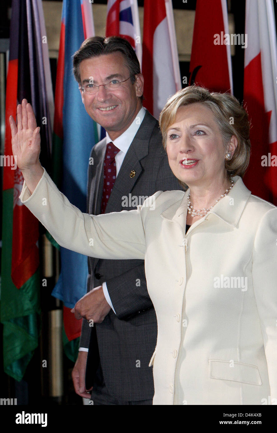 US Secretary of State Hillary Clinton (R) is welcomed by Dutch Minister ...