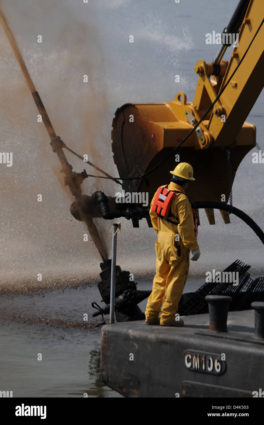 Crews from the U.S. Coast Guard work alongside industry experts to shut ...