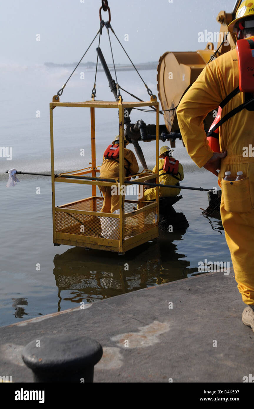 Coast Guard crews work on securing and shutting in a damaged wellhead ...